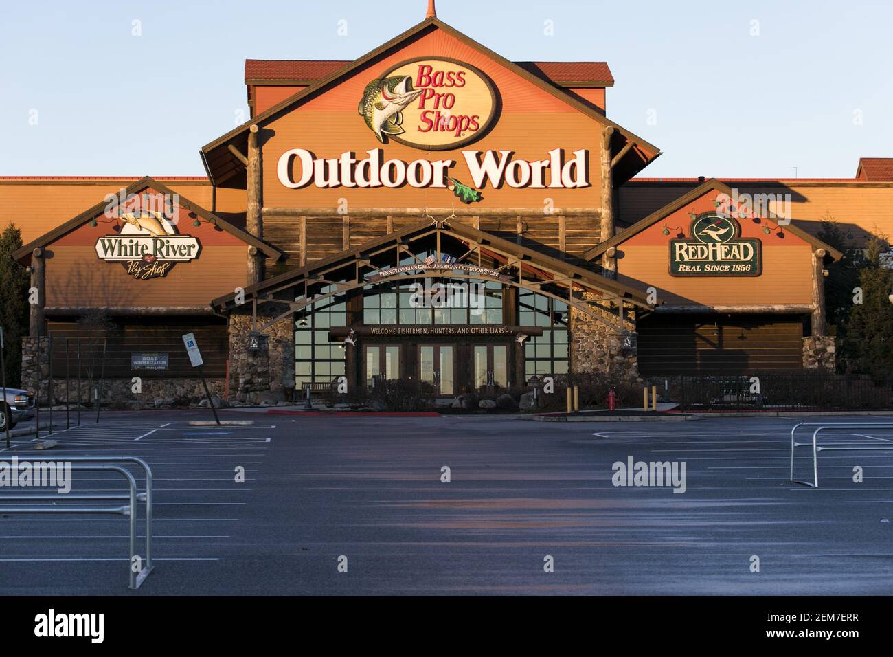 A logo sign outside of a Bass Pro Shops Outdoor World retail store in ...