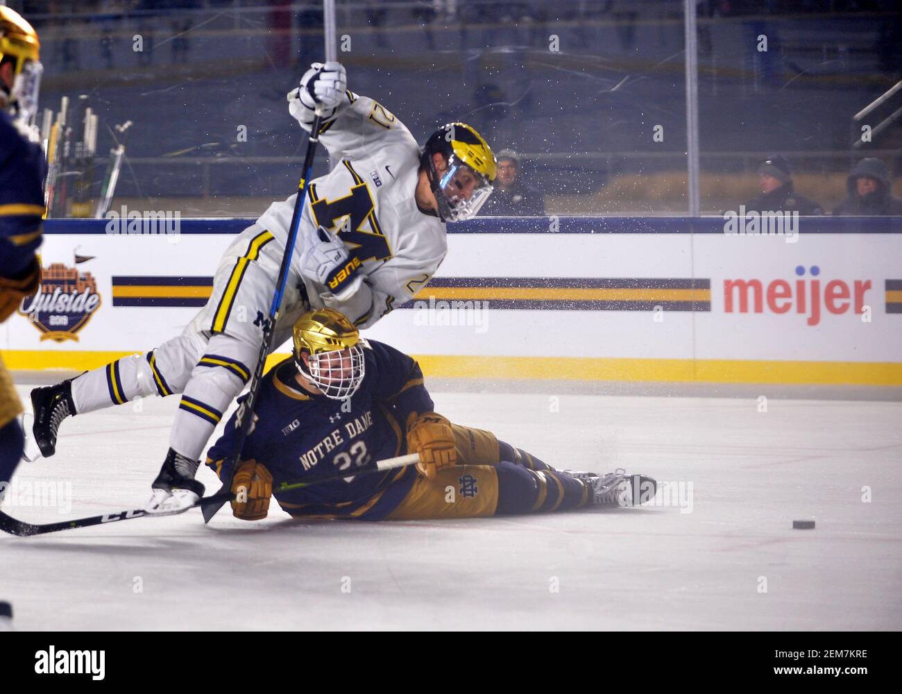 Notre Dame Fighting Irish defenseman Andrew Peeke (22) checks Michigan ...