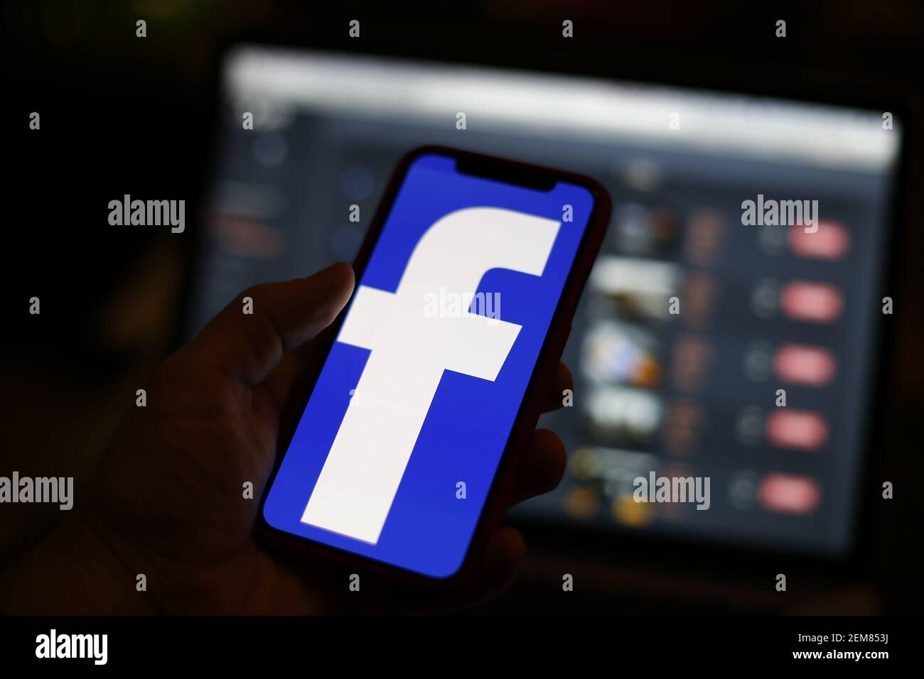 The Facebook logo is seen on a mobile phone in this photo illustration ...