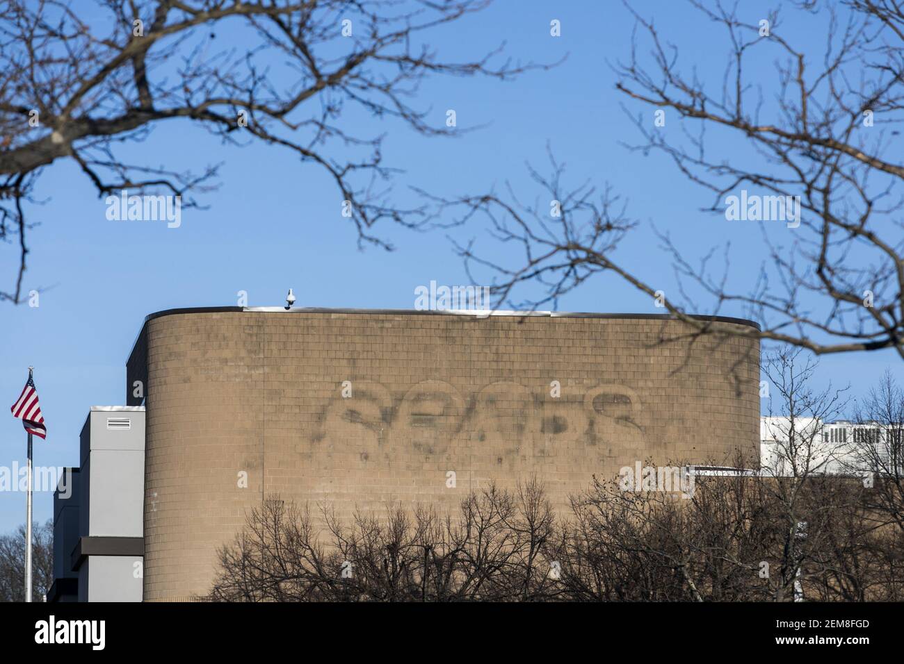 The outline of a Sears logo sign outside of a closed retail store ...