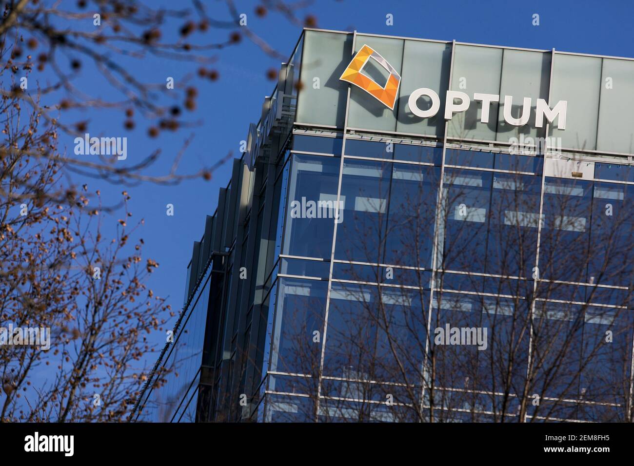 A logo sign outside of a facility occupied by Optum, in Columbia ...