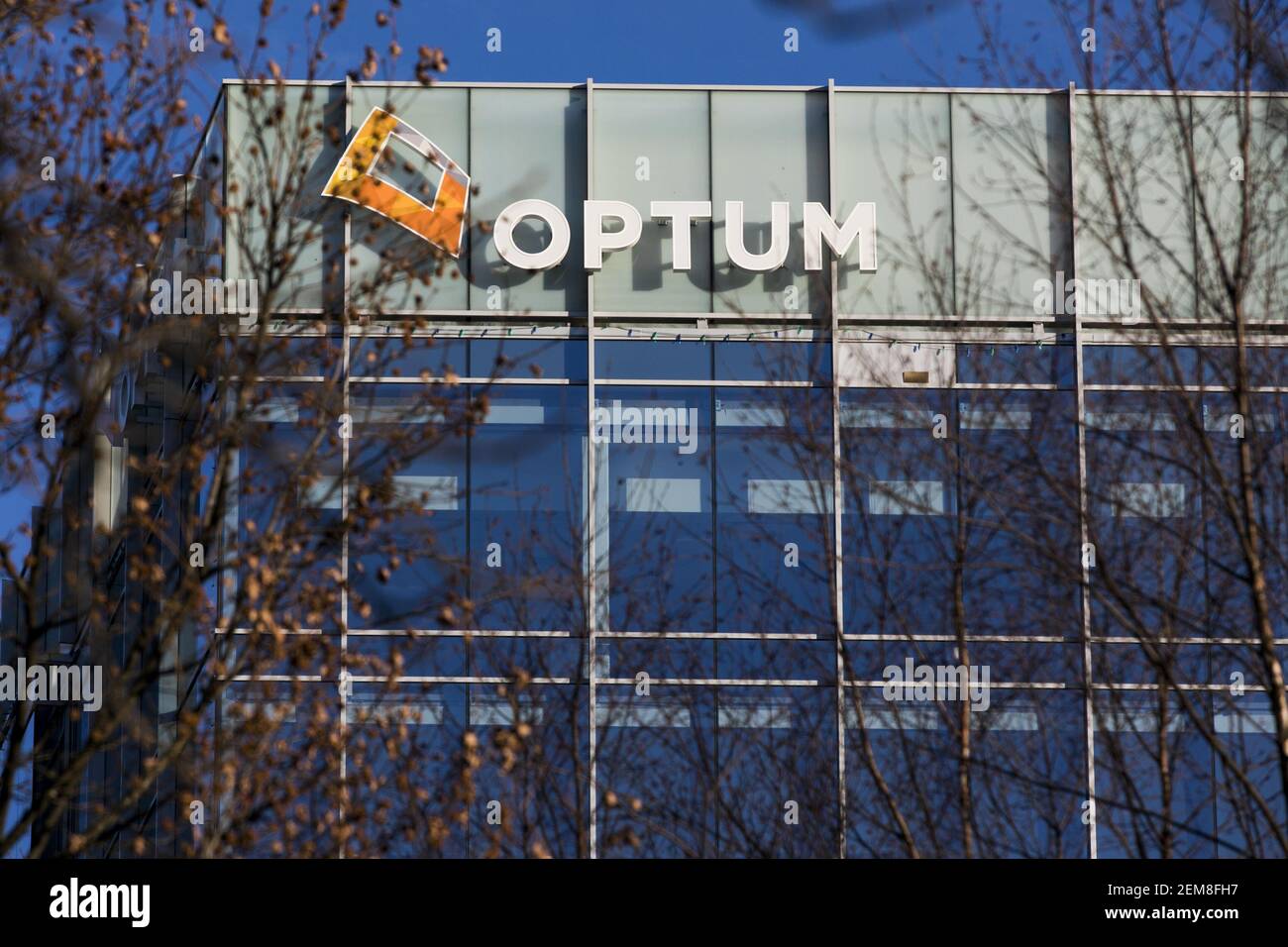 A logo sign outside of a facility occupied by Optum, in Columbia ...