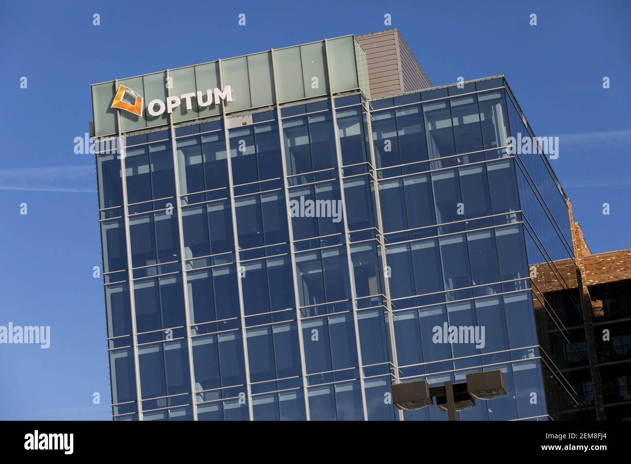 A logo sign outside of a facility occupied by Optum, in Columbia ...