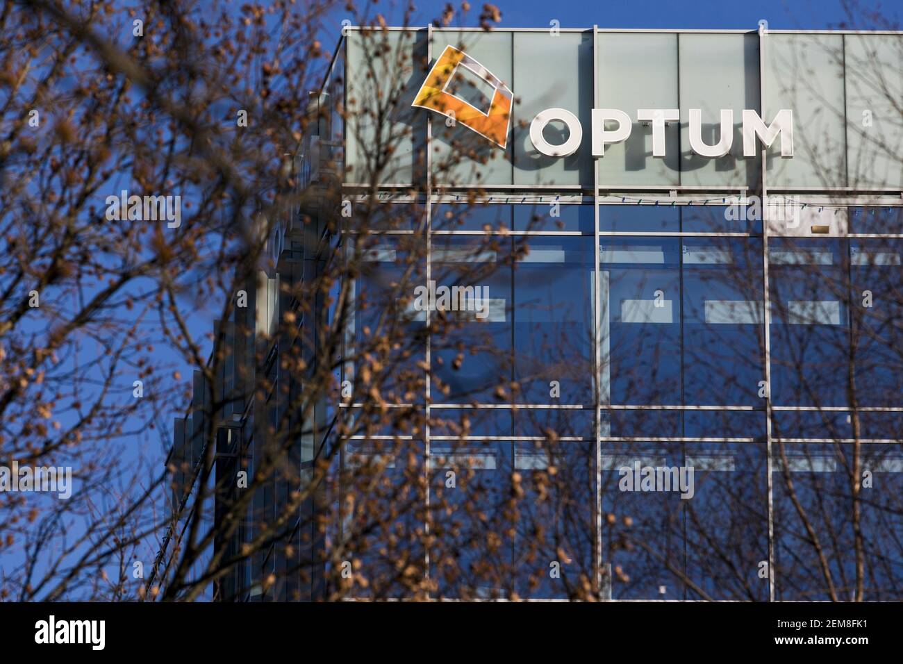 A logo sign outside of a facility occupied by Optum, in Columbia ...