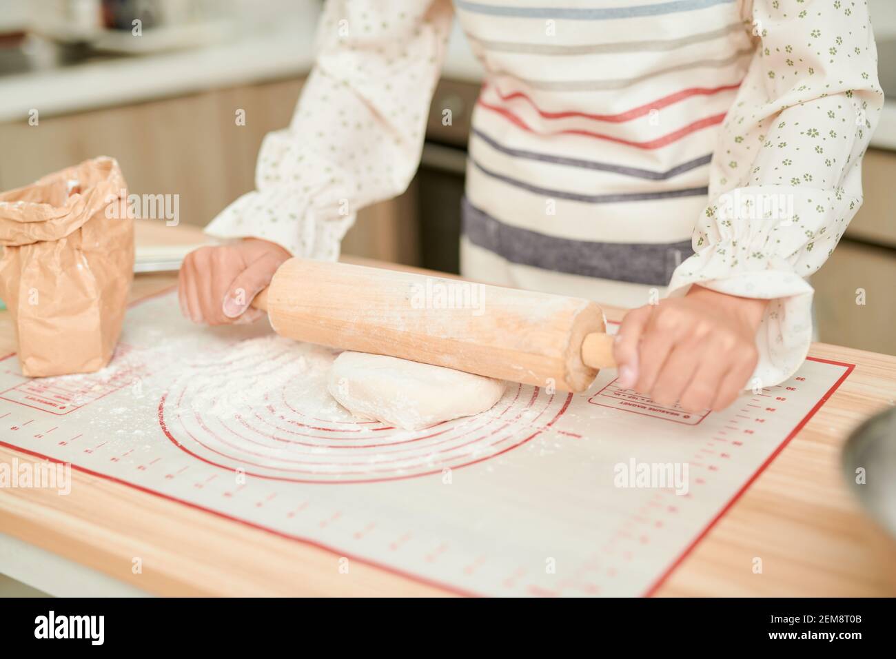 cooking and home concept - close up of female working with rolling-pin ...