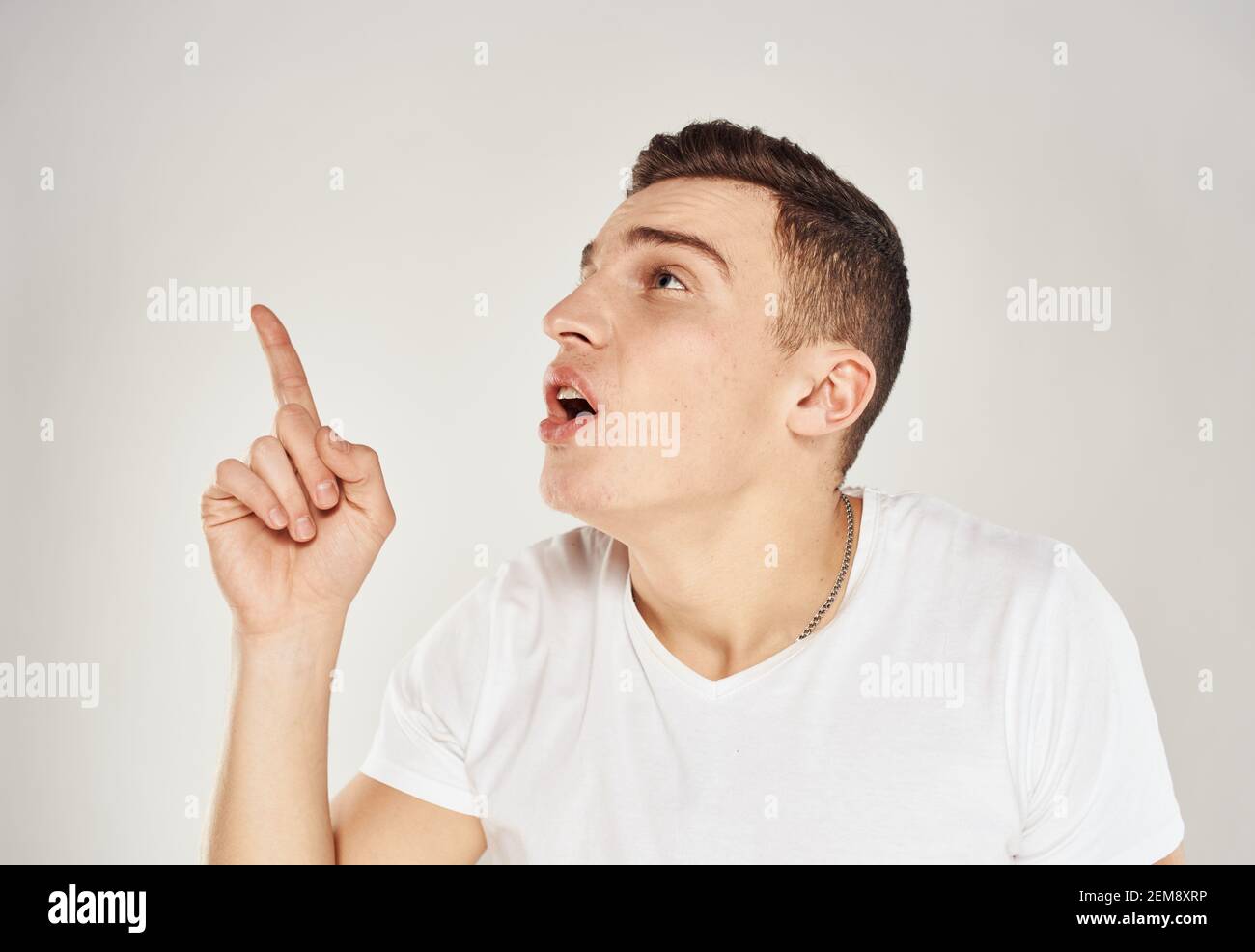 Male puzzled look face sleeves model white t-shirt Stock Photo - Alamy