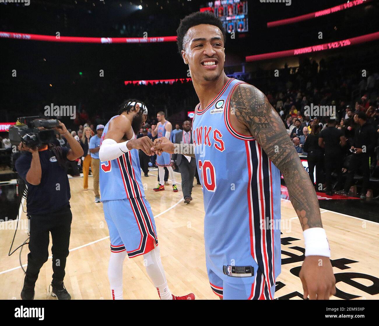 The Atlanta Hawks' John Collins, right, and DeAndre Bembry celebrate a ...