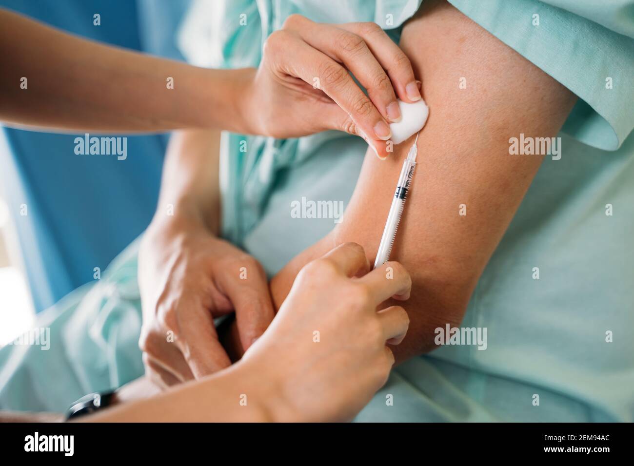 Nurse giving male patient injection hi-res stock photography and images ...