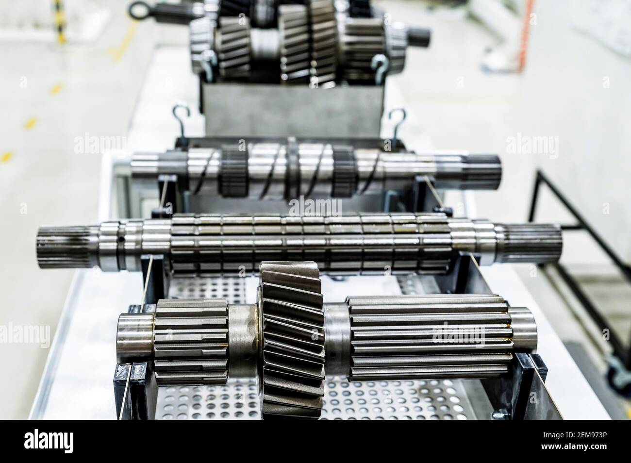 Brand new shaft gear for transmission. Spare parts in assembly workshop ...