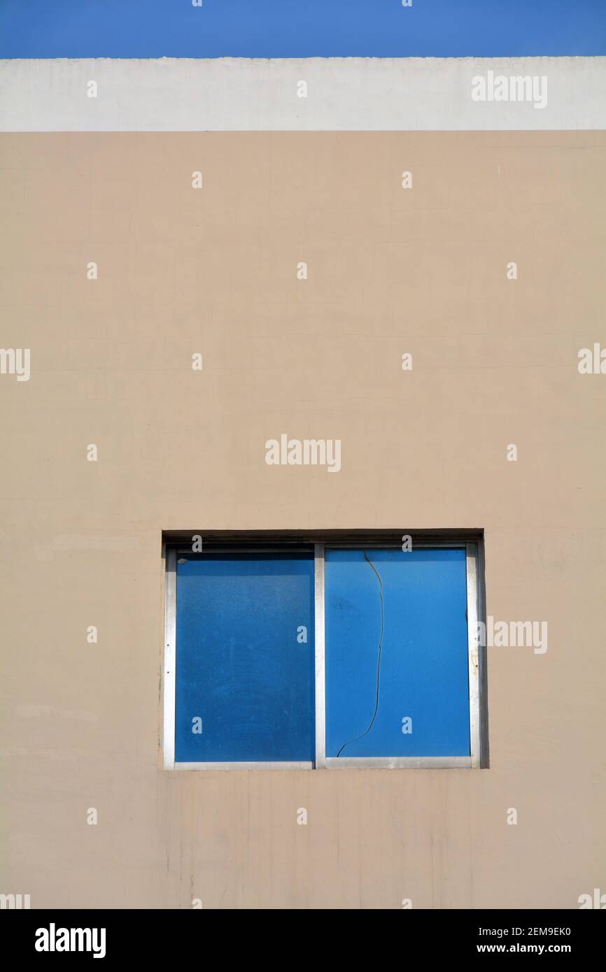 Single window frame with blue glass mirroring the blue sky above Stock ...