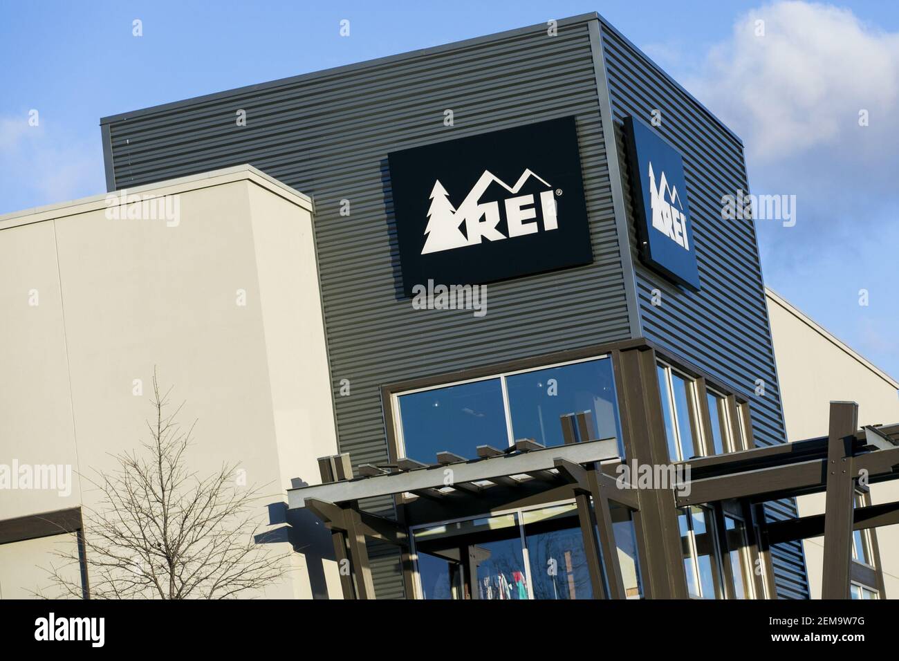 A logo sign outside of a REI (Recreational Equipment, Inc.) retail ...