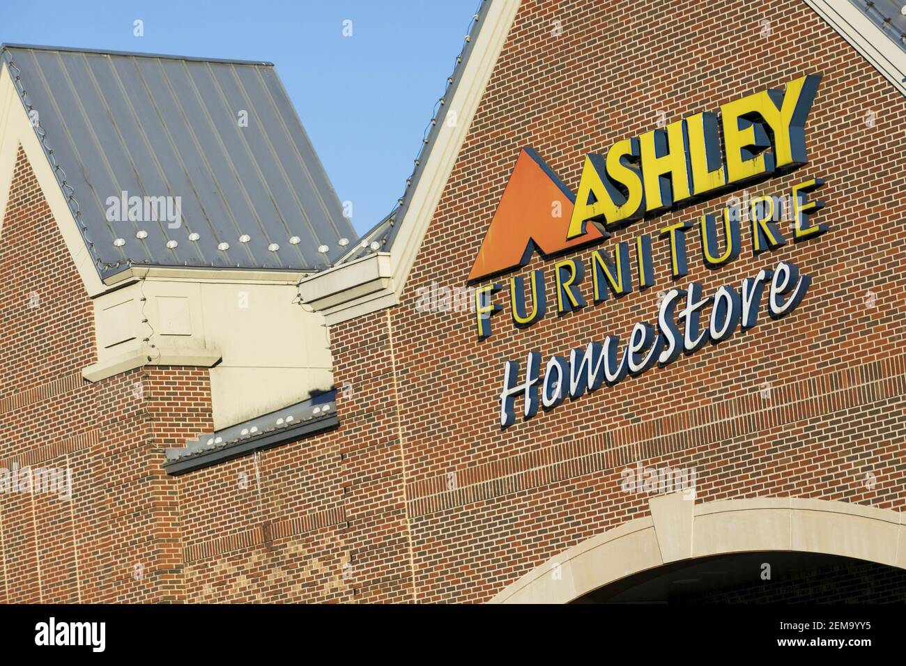 A logo sign outside of a Ashley Furniture HomeStore retail store in ...