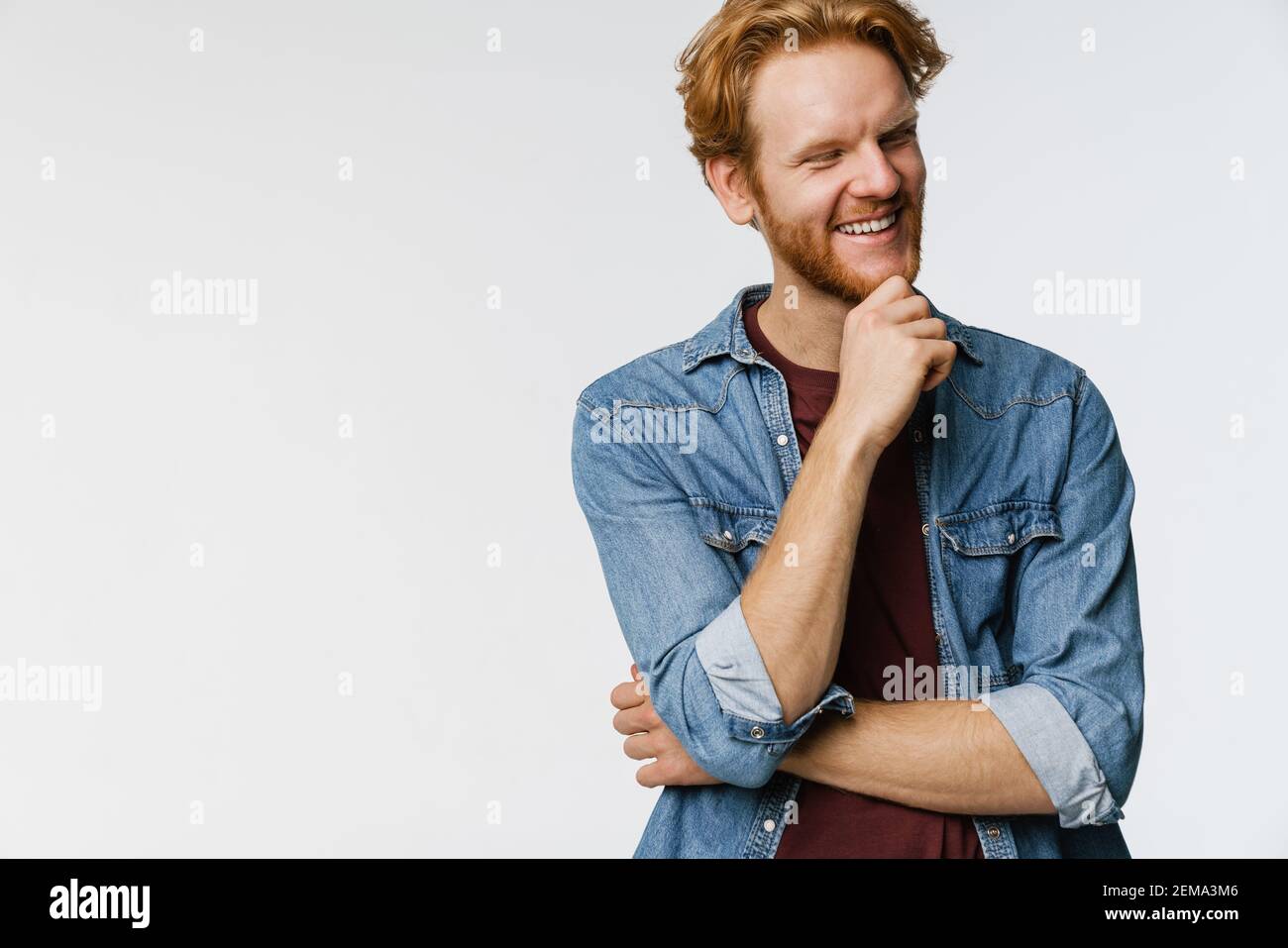 Joyful handsome guy laughing and posing at camera isolated over white ...