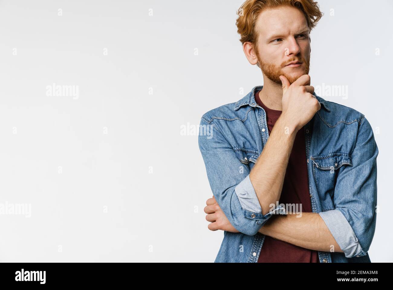 Brooding handsome ginger guy posing and looking aside isolated over ...