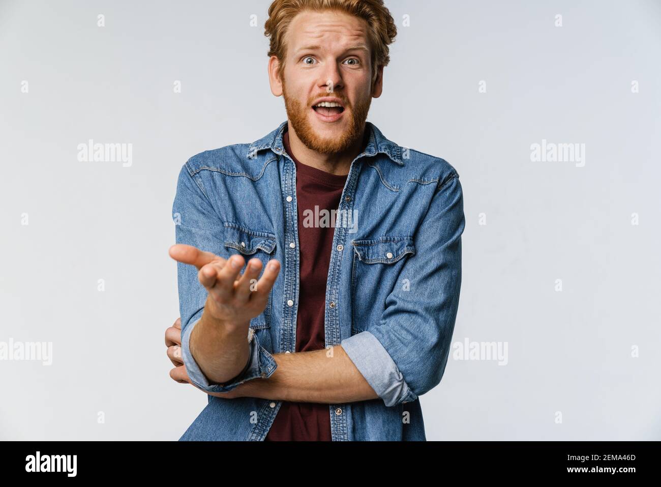 Nervous handsome guy resenting and pointing finger at camera isolated ...