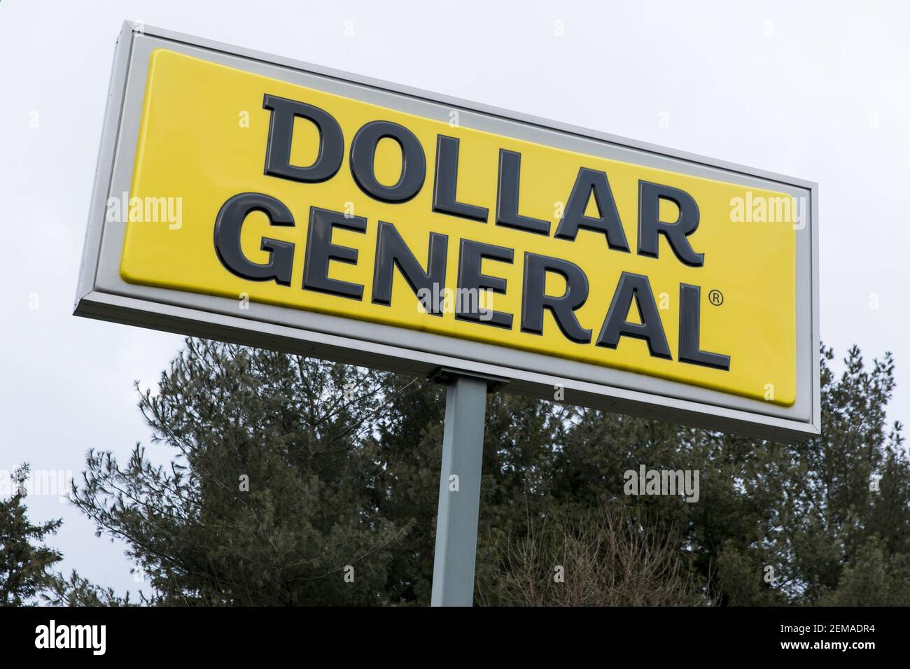 A logo sign outside of a Dollar General retail store location in ...