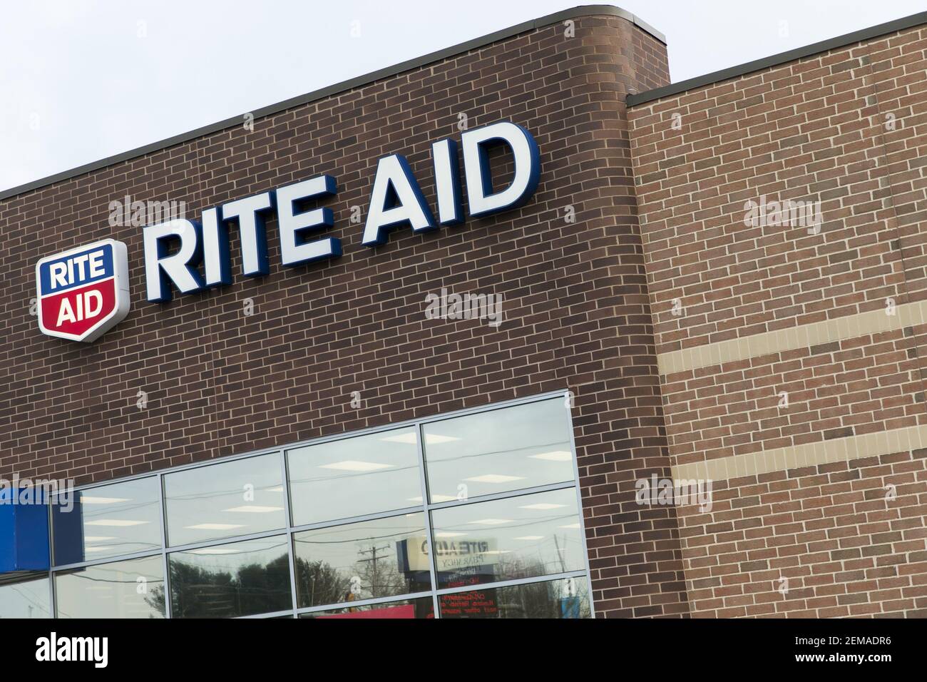 A logo sign outside of a Rite Aid pharmacy and retail store location in ...