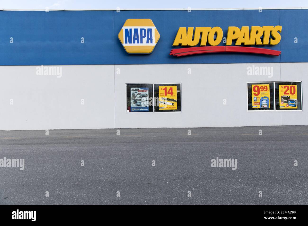 A logo sign outside of a NAPA Auto Parts retail store location in ...