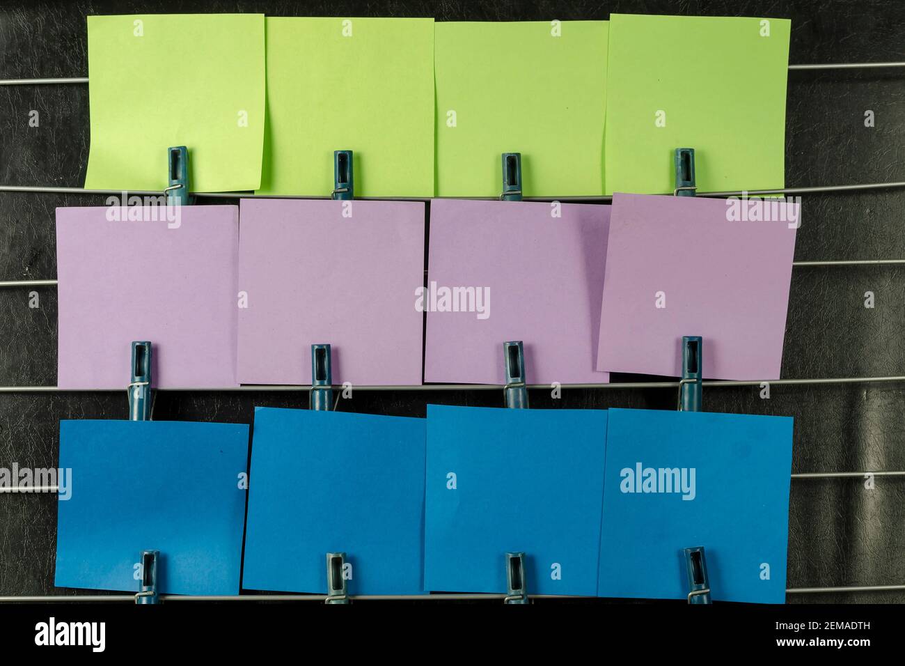 The paper sticky notes hanging from clothespins. Set of multicolored ...