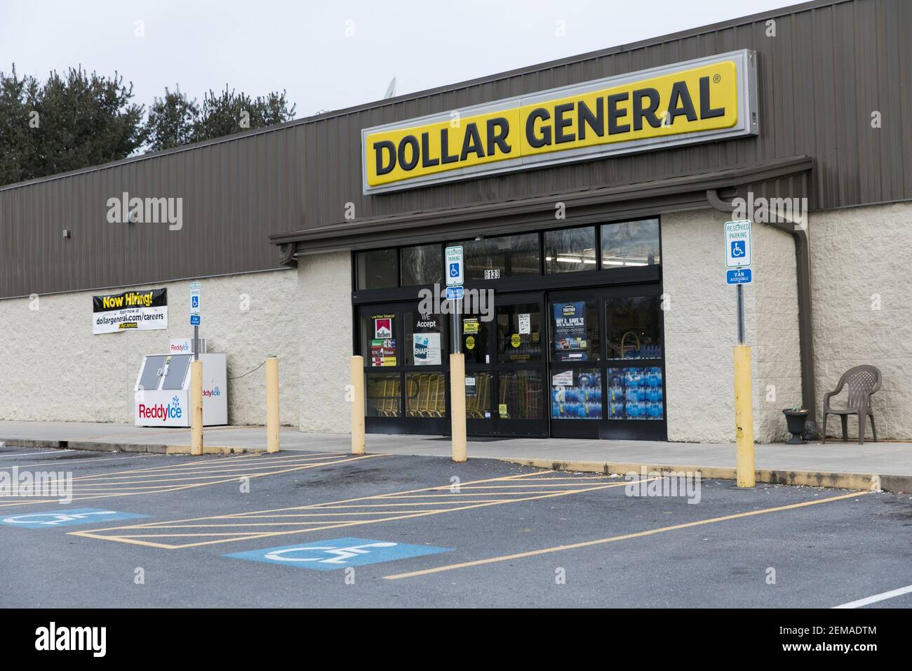 A logo sign outside of a Dollar General retail store location in ...