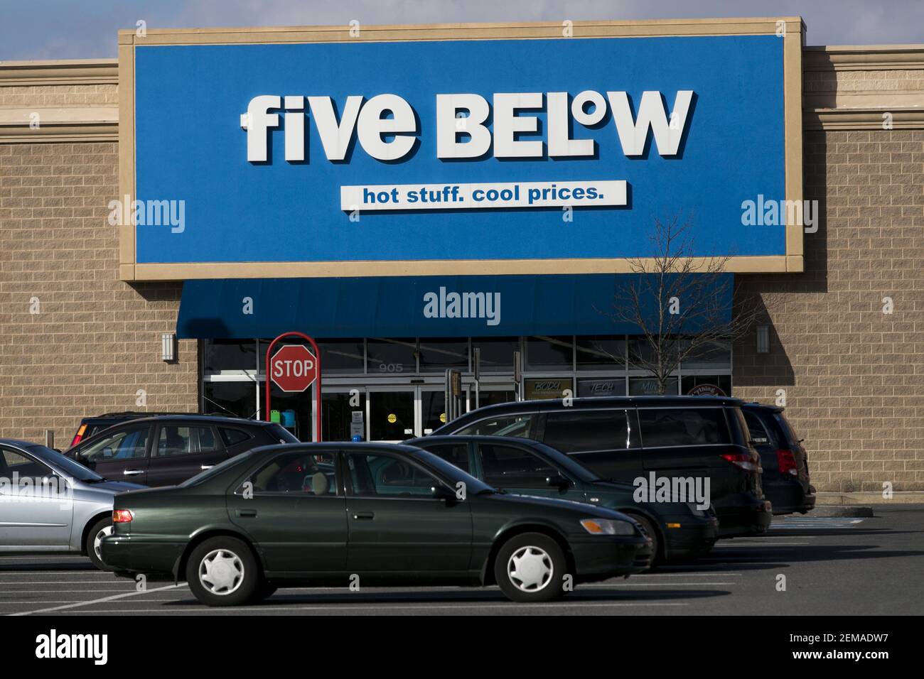 A logo sign outside of a Five Below retail store location in ...