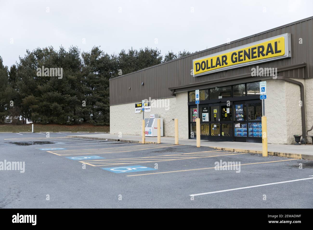 A logo sign outside of a Dollar General retail store location in ...