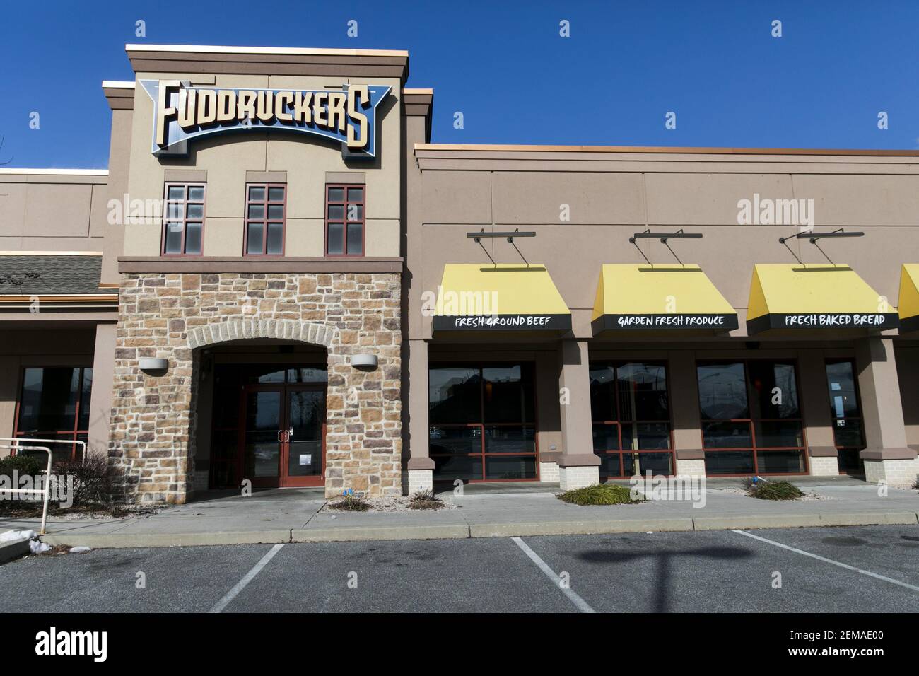 A logo sign outside of a Fuddruckers restaurant location in ...