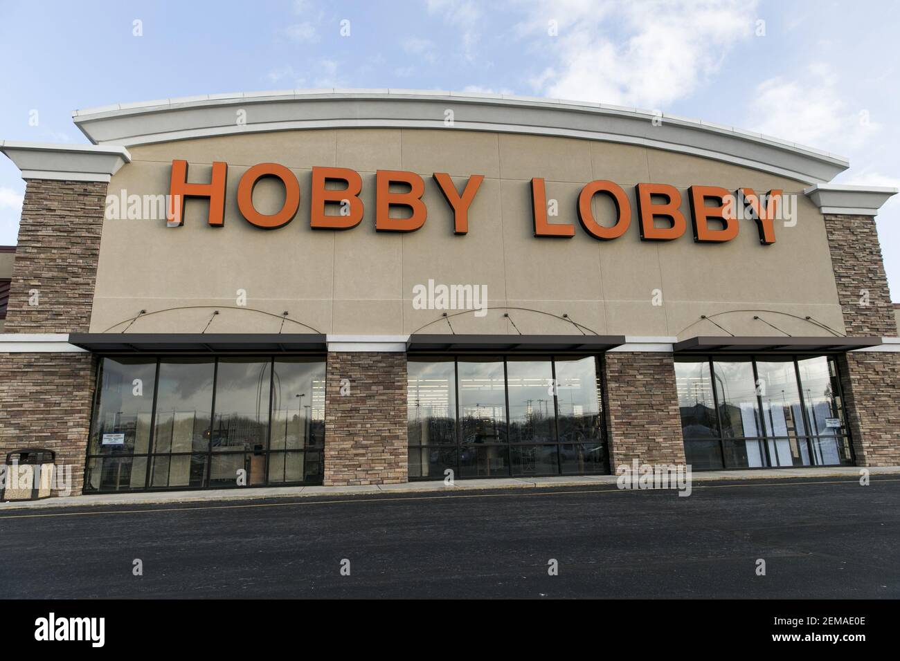 A logo sign outside of a Hobby Lobby retail store location in ...