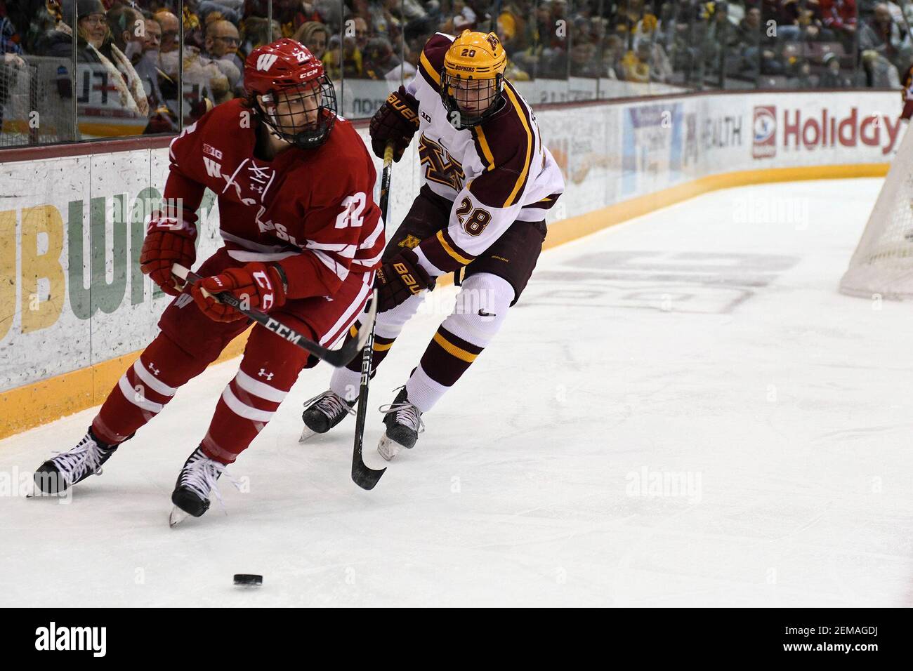 Wisconsin's Max Zimmer (22) skates with the puck ahead of Minnesota ...