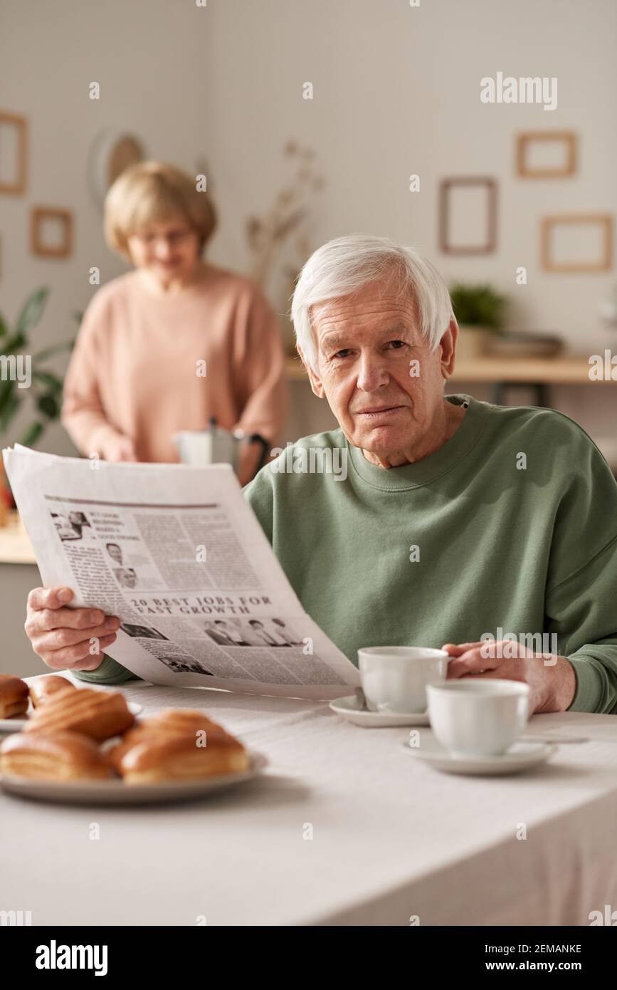 Portrait smiling man sitting breakfast table newspaper hi-res stock ...