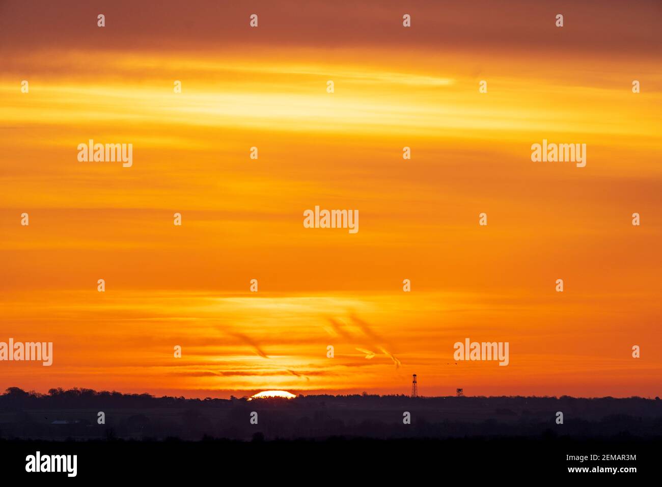 Telephoto view of the sunrise over the Kent landscape. Horizon low in ...