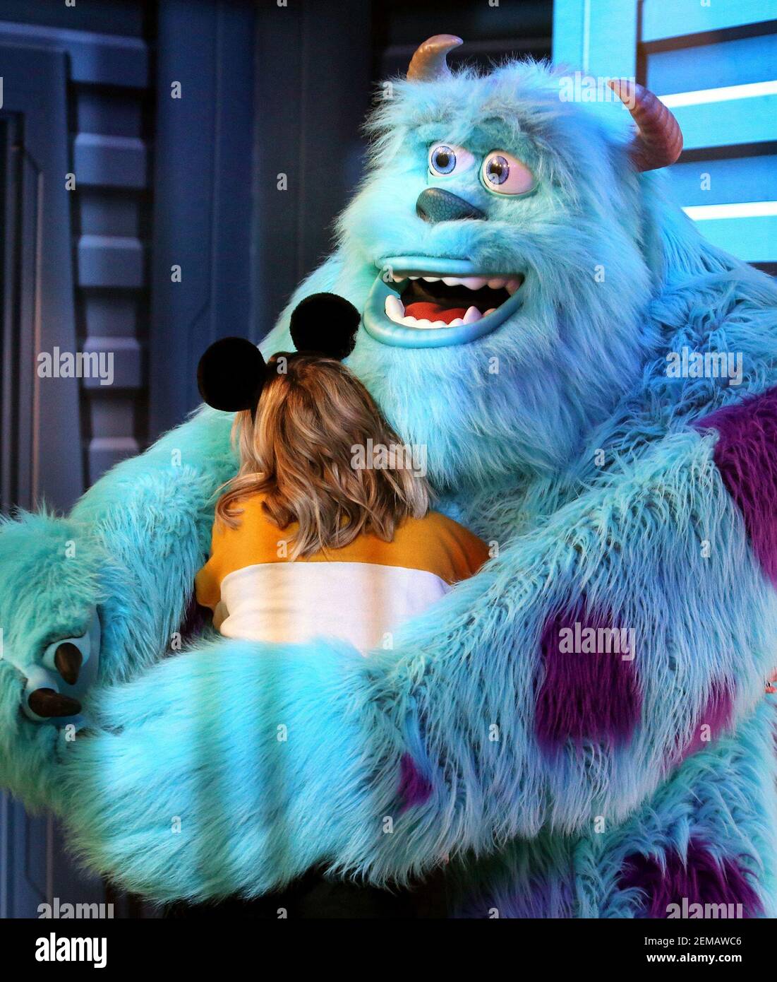 Pixar character Sulley, from Monsters, Inc., hugs a guest at the debut ...