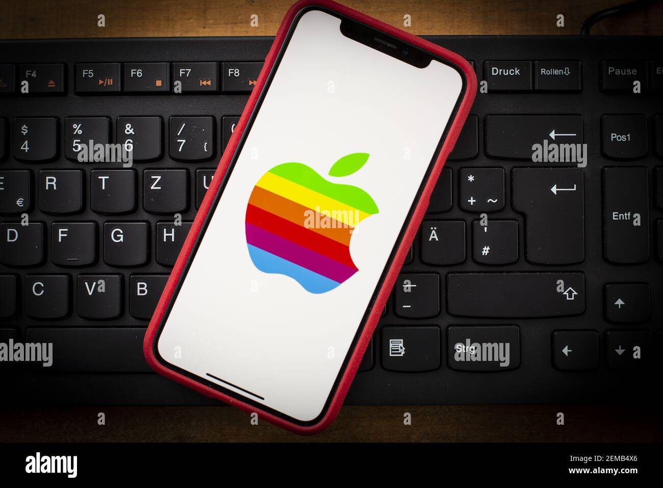 The Apple logo is seen on a mobile phone in this photo illustration on ...