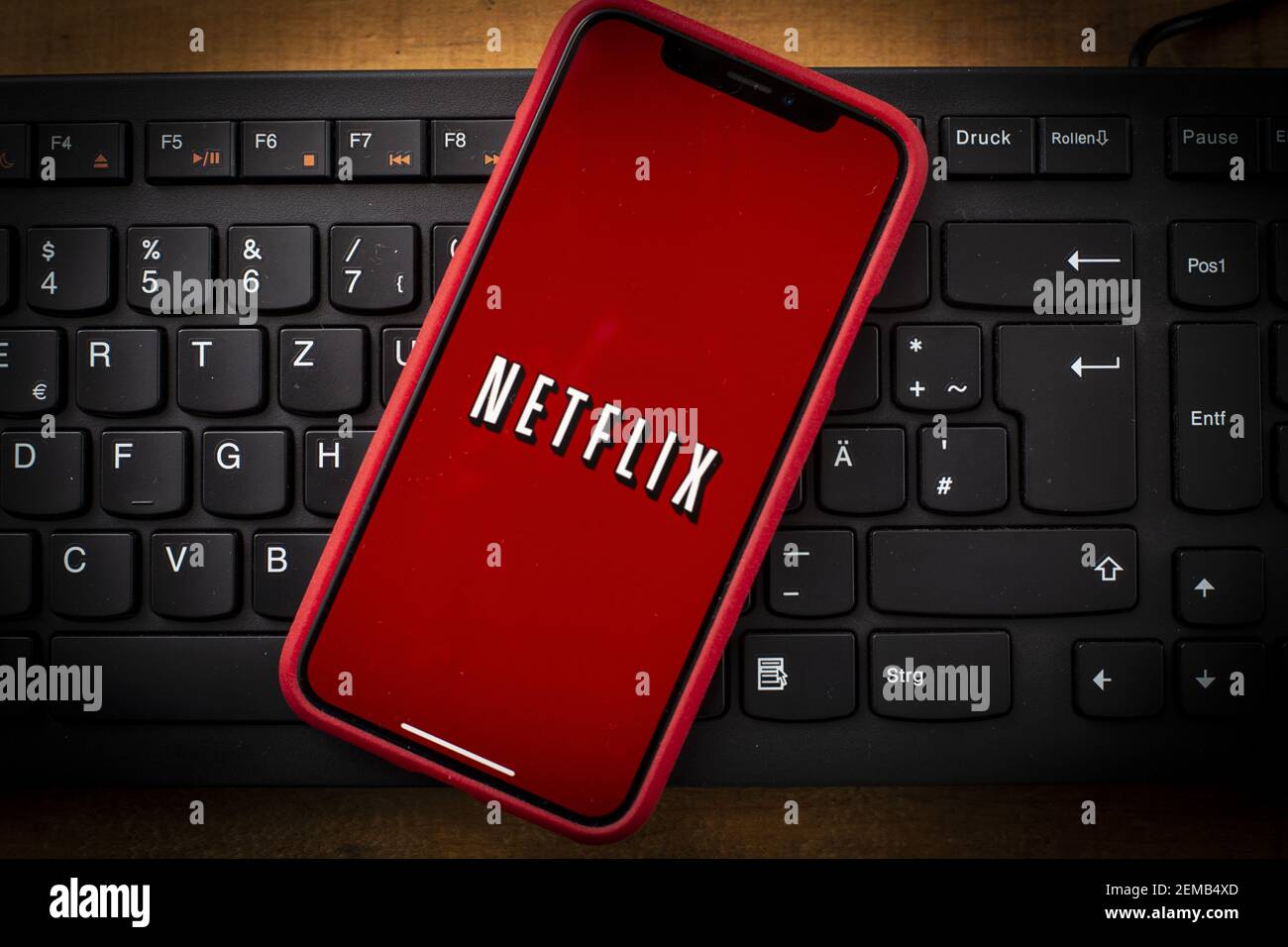 The Netflix logo is seen on a mobile phone in this photo illustration ...
