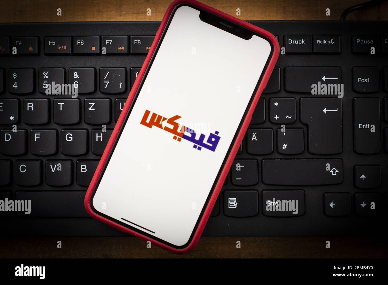 The FedEx logo in Arabic is seen on a mobile phone in this photo ...