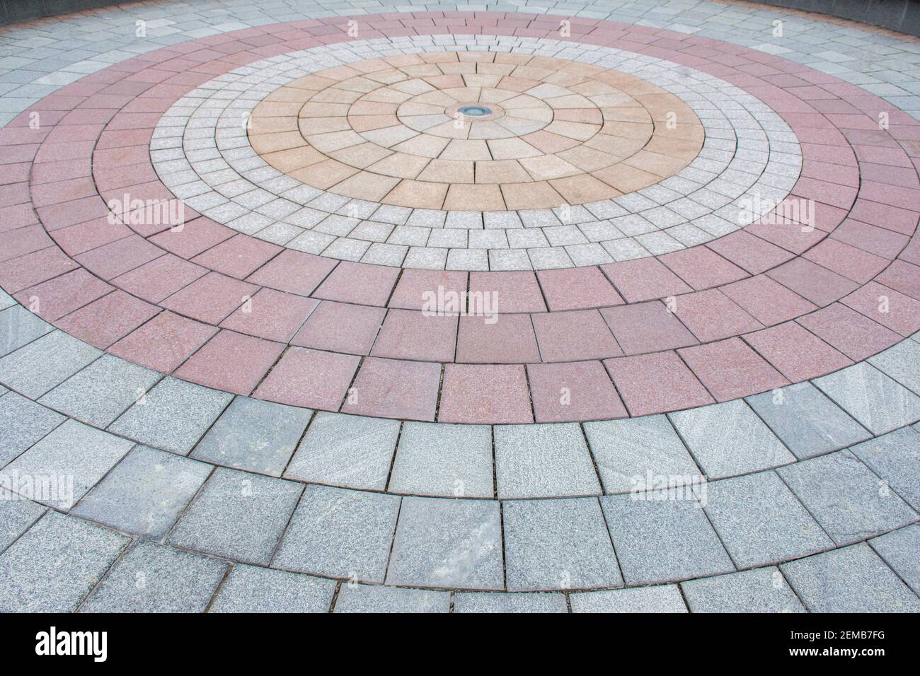 Pavement laid out with red, yellow and gray stones for decoration in ...