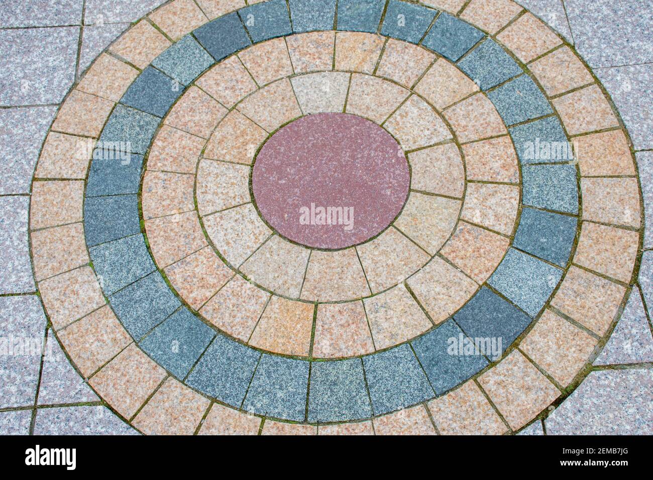 Pavement laid out with red, yellow and gray stones for decoration in ...