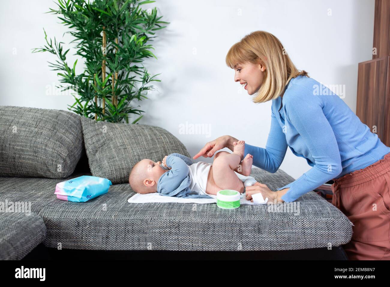 Young mother changing the diapers of her baby boy Stock Photo - Alamy