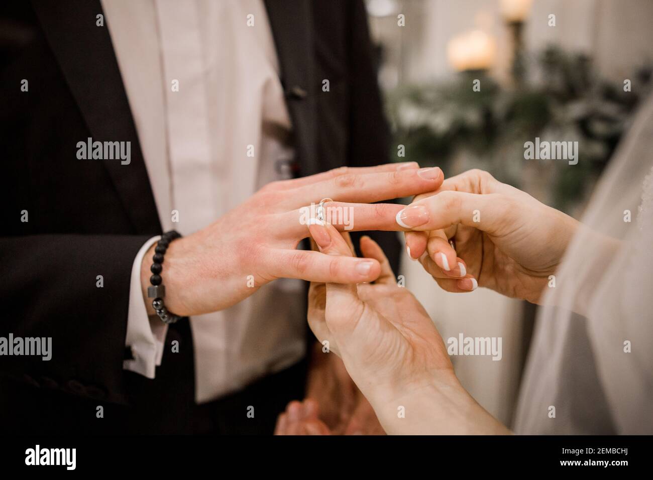 a groom and bride dress wedding rings to each other Stock Photo - Alamy