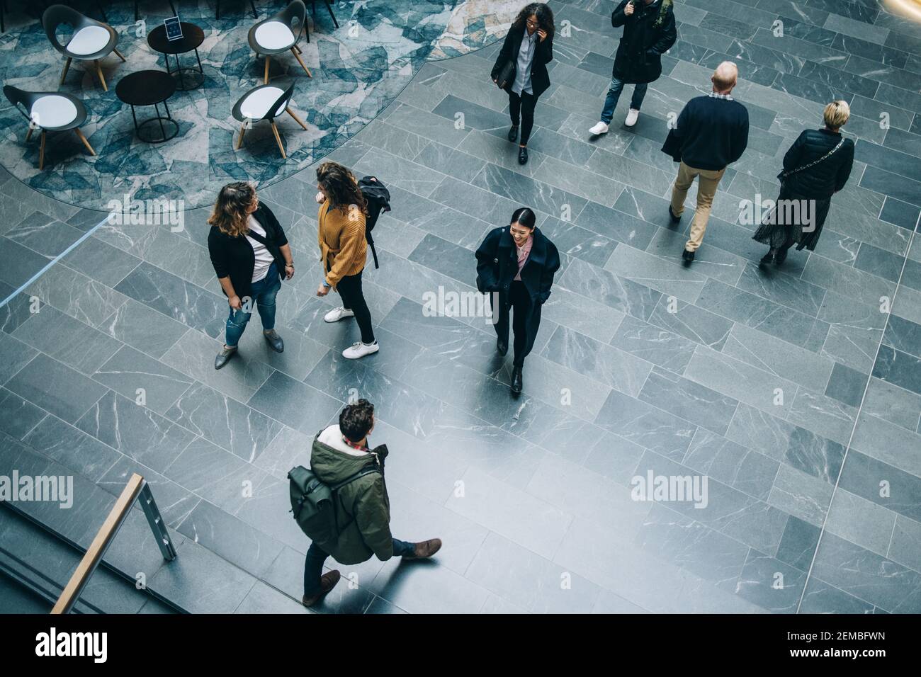 Crowd of people in modern office building hallway. business people ...