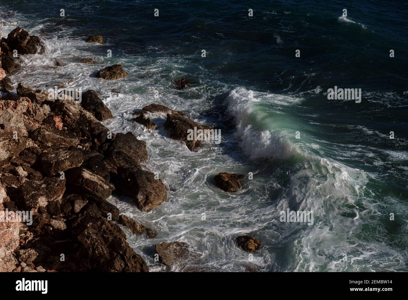 Ocean wave background breaking sea water rocky shore rough seas ...