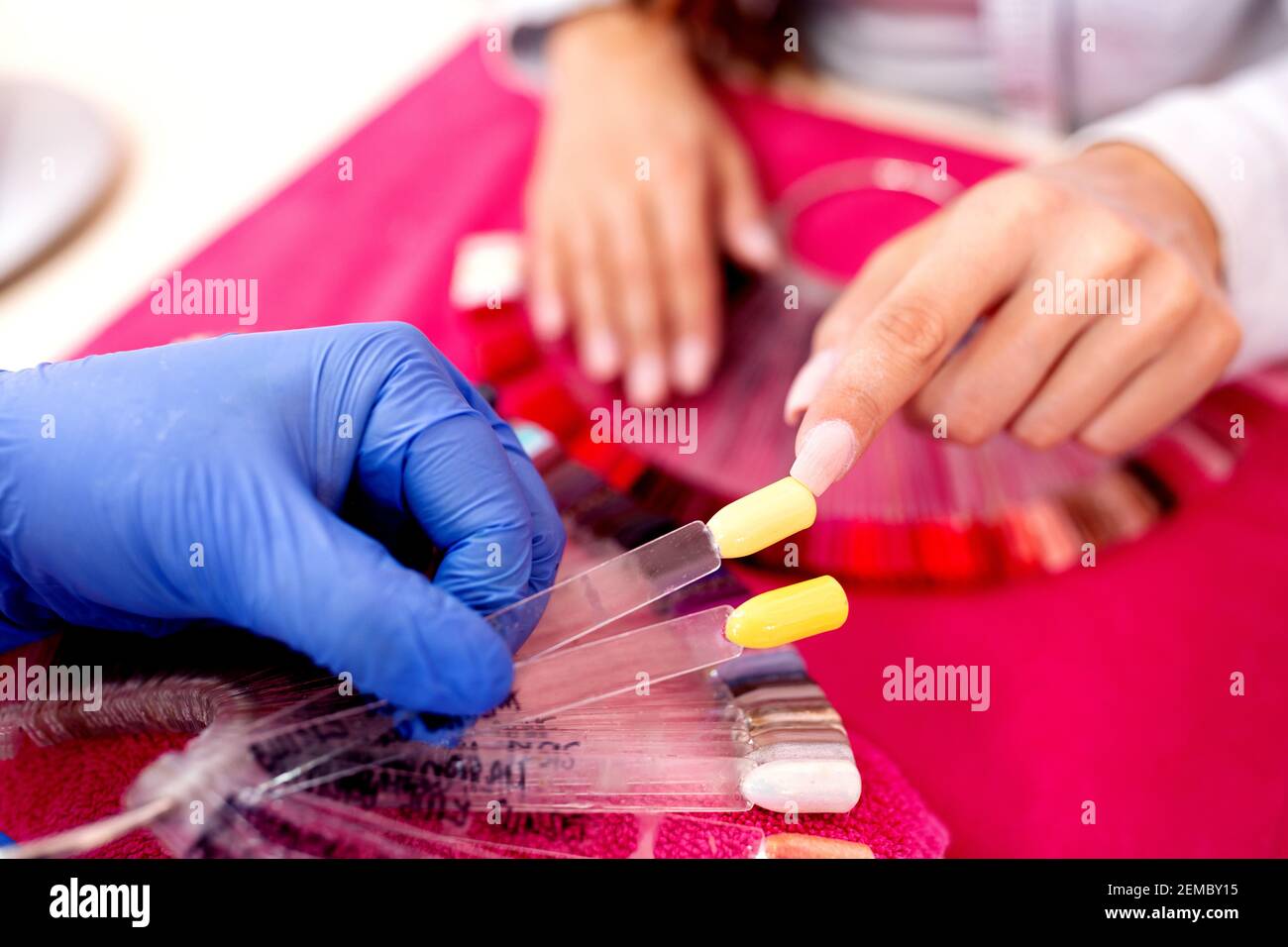 Nail color palette and curious fingers, manicure salon Stock Photo - Alamy