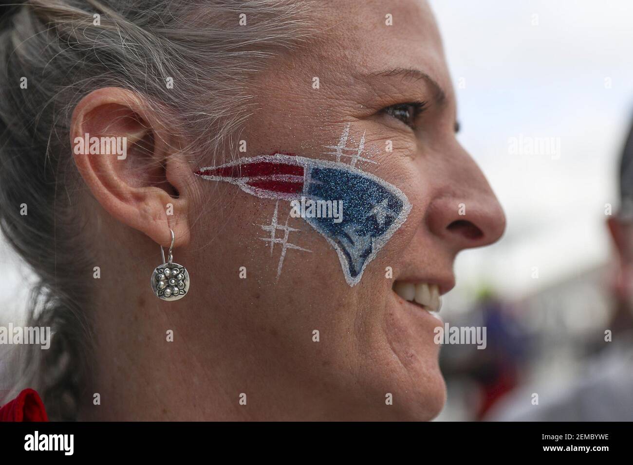 A New England Patriots fan shows off her face paint before the start of ...