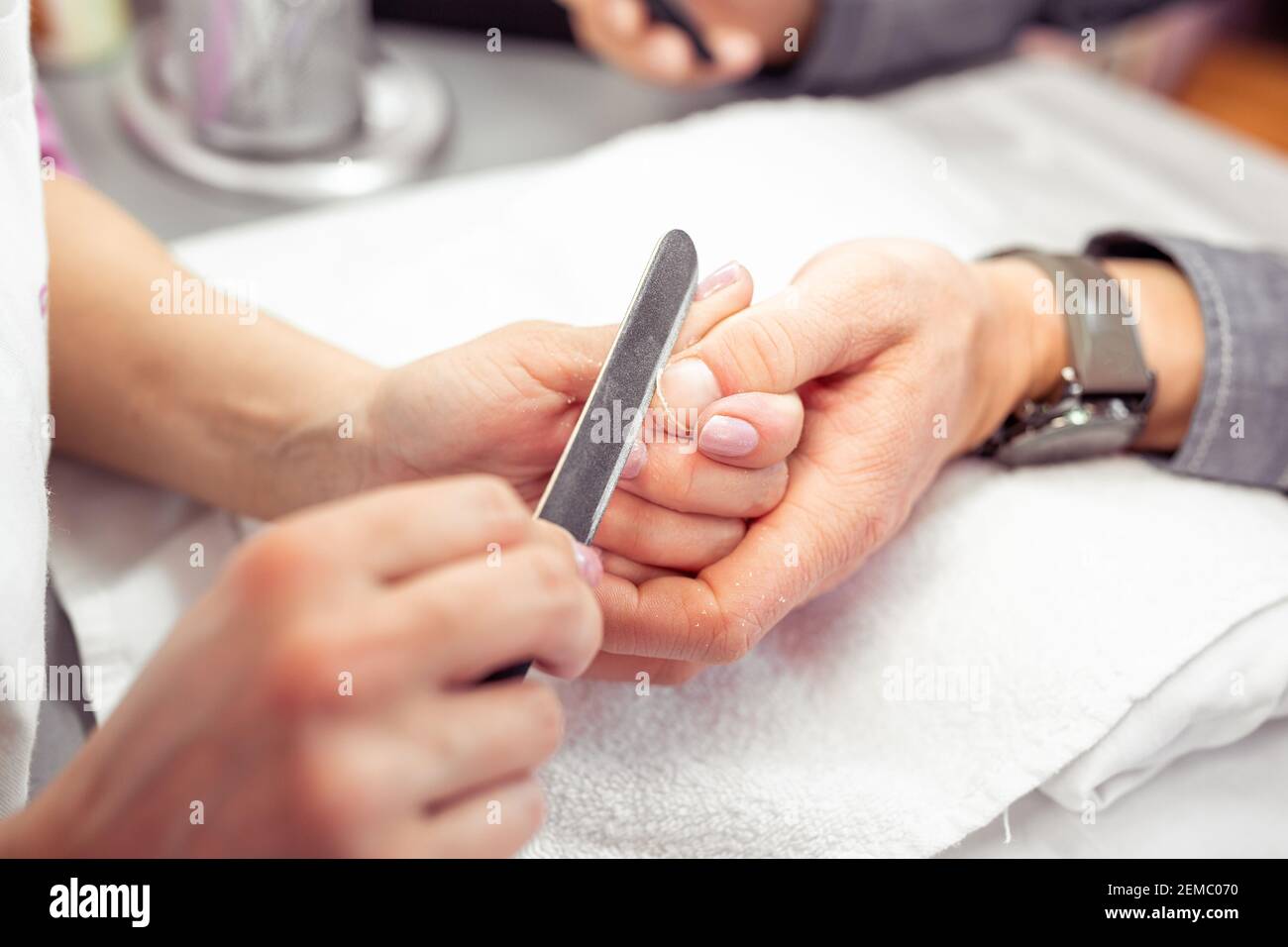 Manicure treatment on a man’s hand in nail salon Stock Photo - Alamy