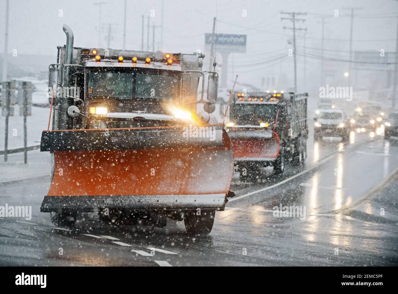 Snow plows drive along at Harford Road and Bel Air Bypass as snow falls ...