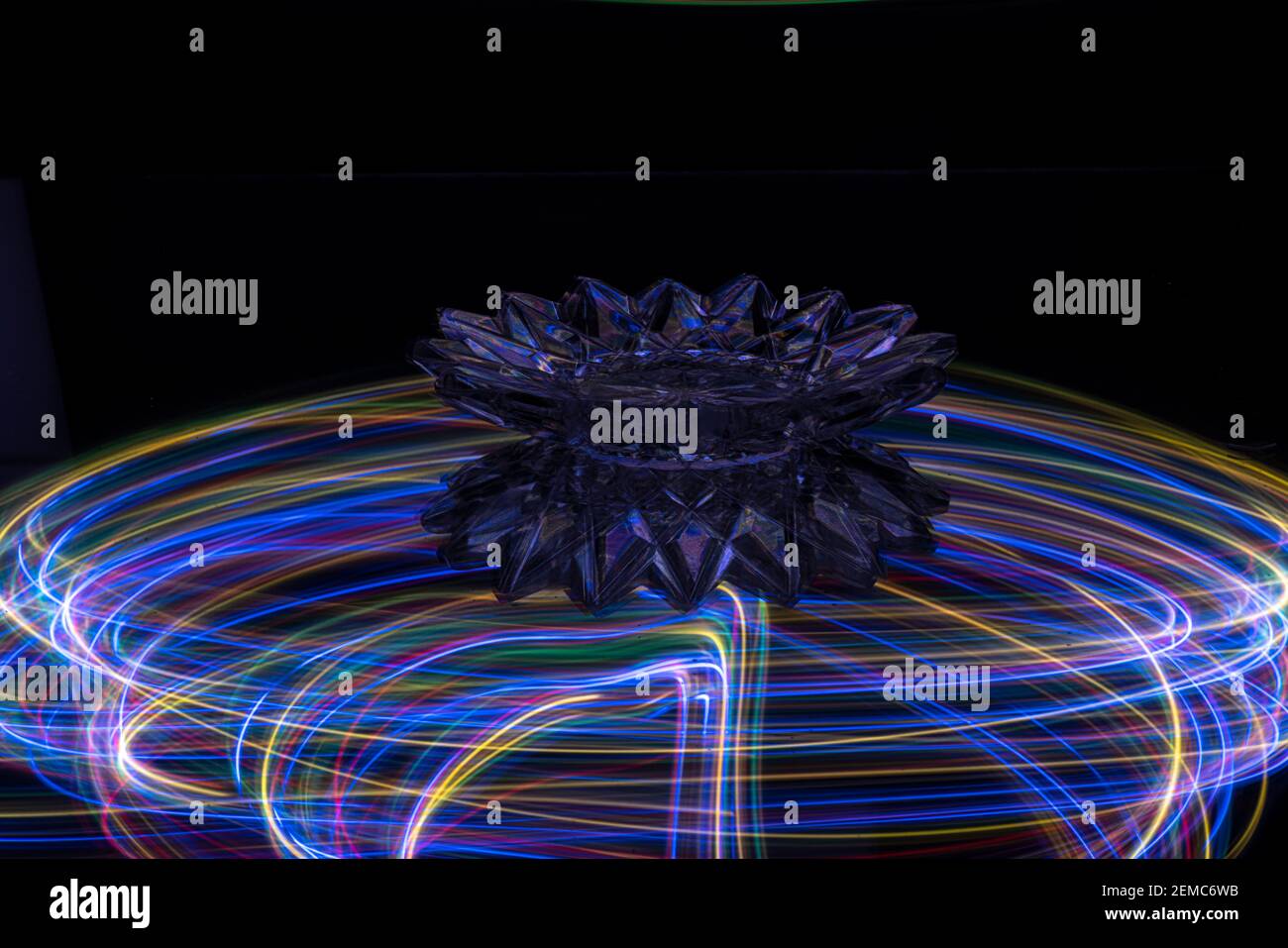 Painting with light on a mirror with small colored lamps and a glass ...