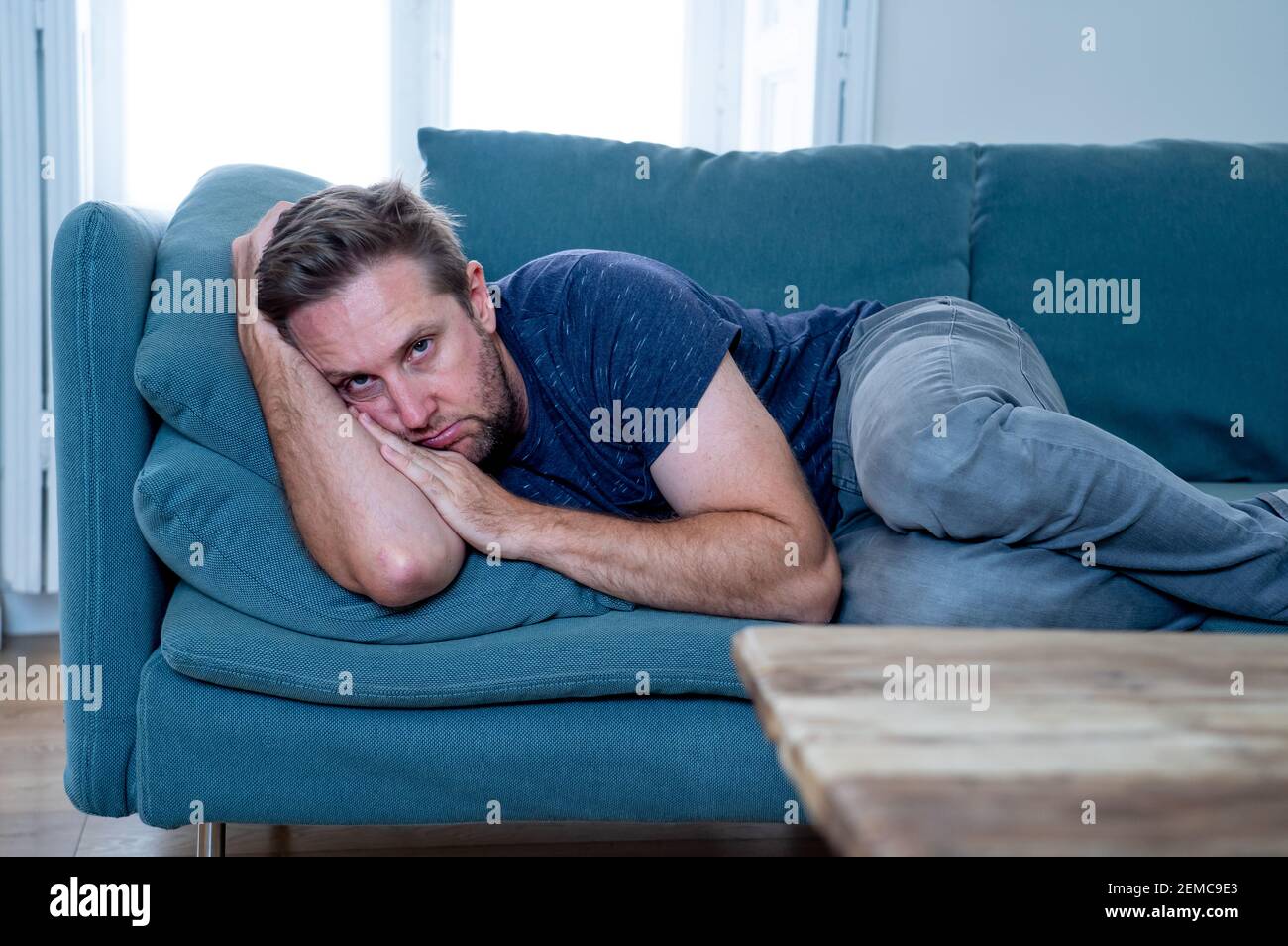 Unhappy depressed caucasian male crying in living room couch feeling ...
