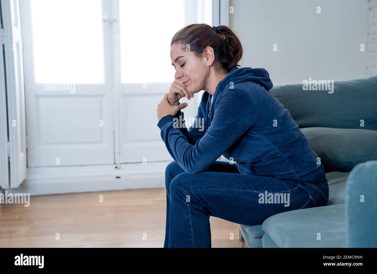 Young lonely attractive latin woman crying on couch feeling sad tired ...