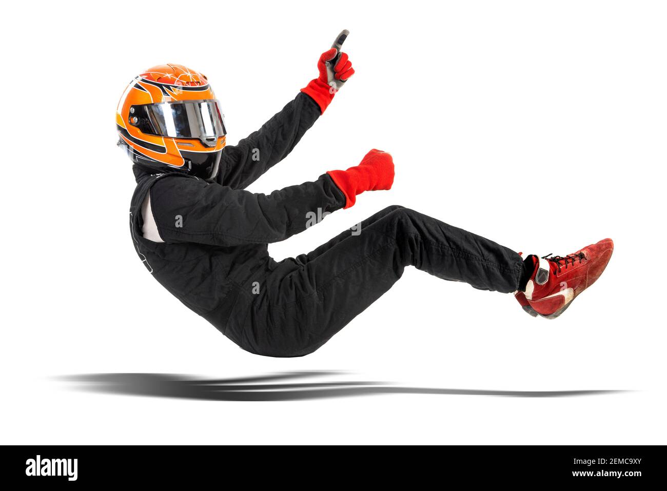 Racing driver in full gear in racing position isolated in a white ...