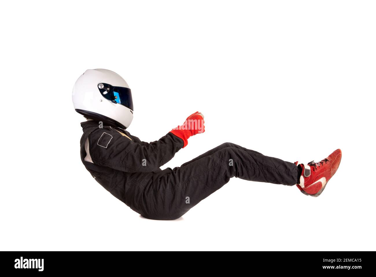 Racing driver in racing position with complete gear isolated in white ...